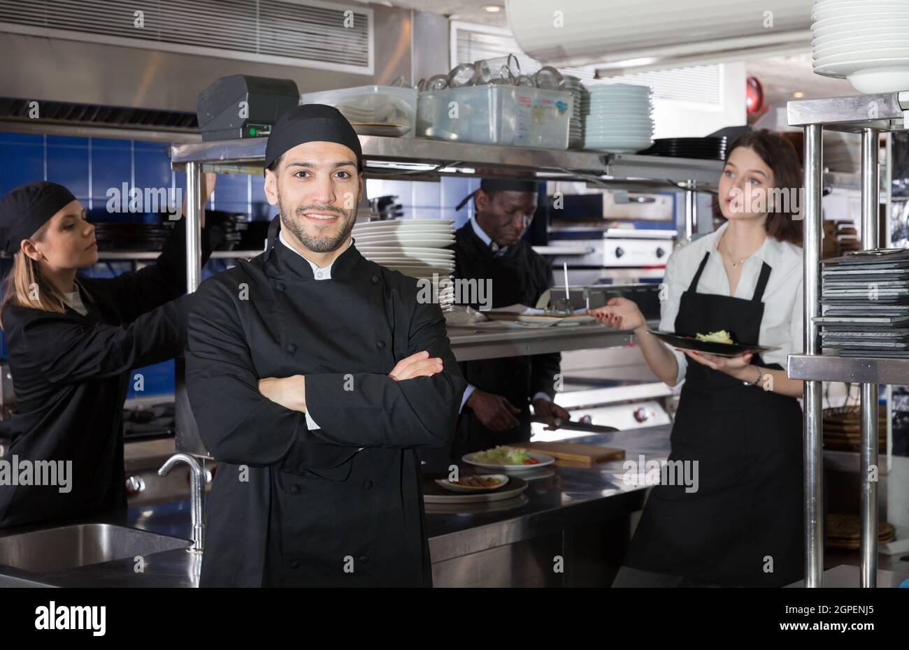 Smiling male restaurant worker posing hi-res stock photography and ...