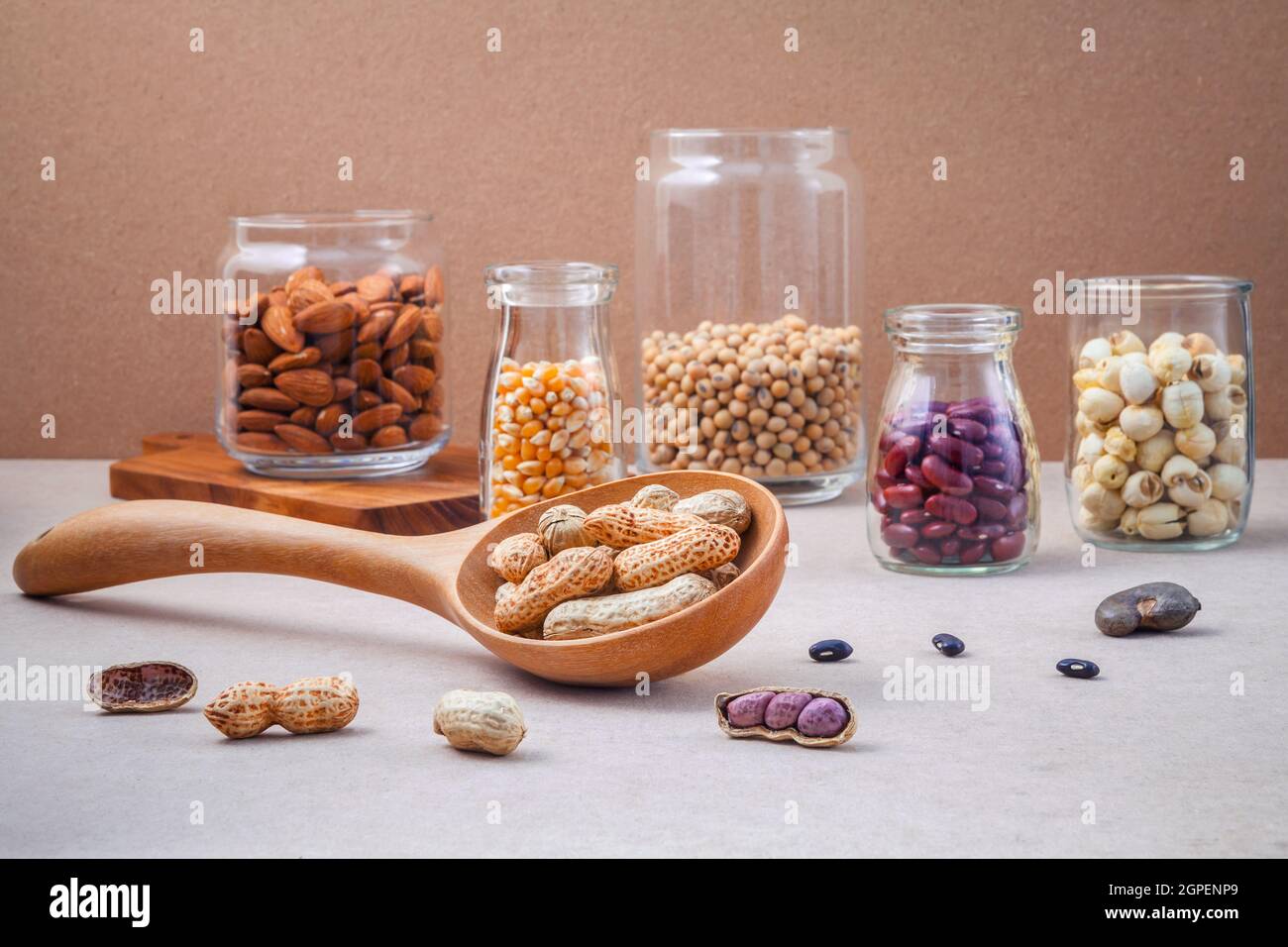 Various beans and nuts in the glass on brown background. mung bean ...