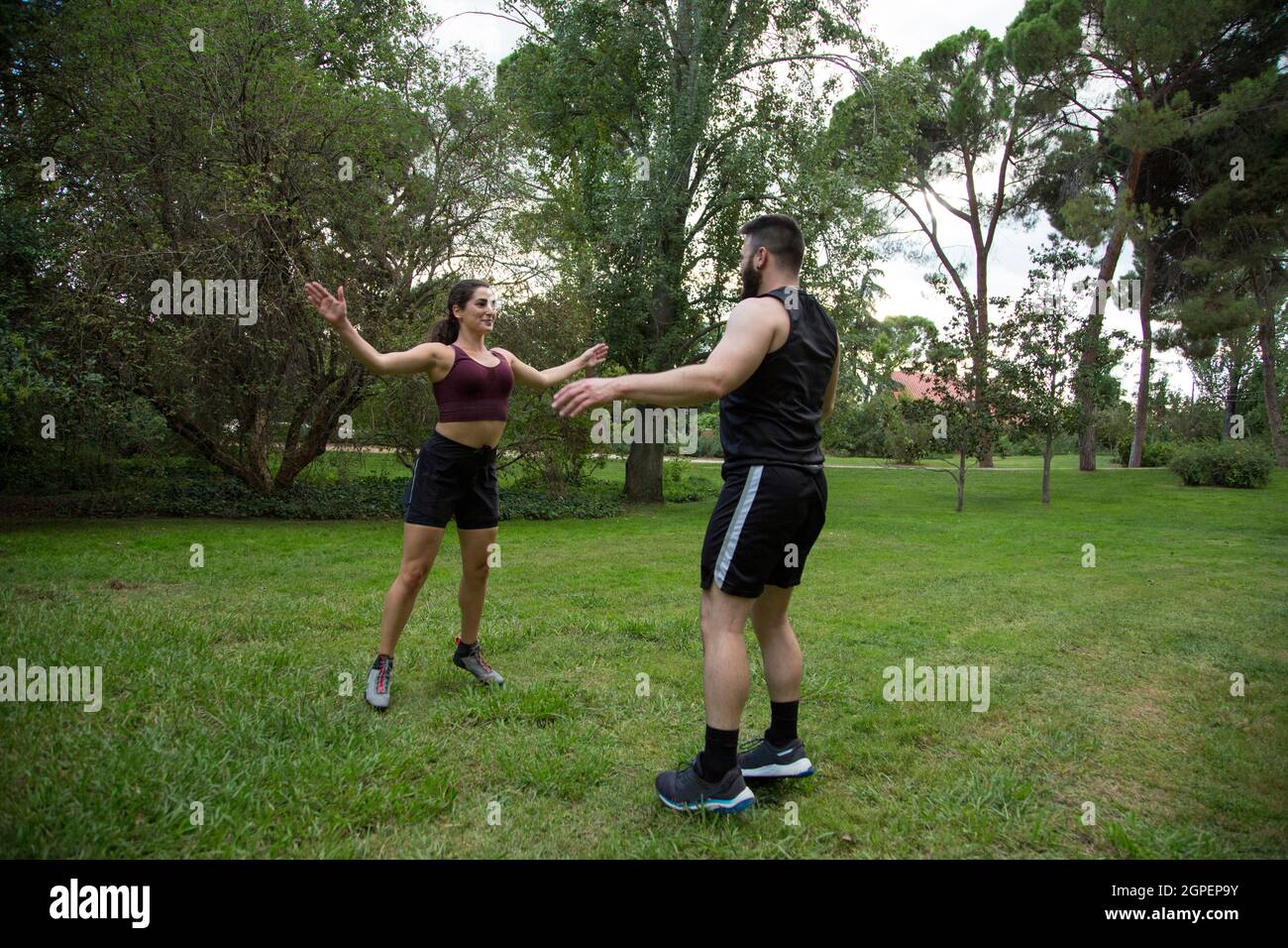 young happy caucasian man and woman couple practicing burpee in the ...