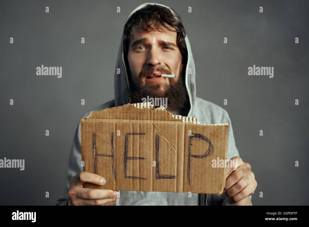 poor man with a beard sign help the tramp lifestyle Stock Photo - Alamy