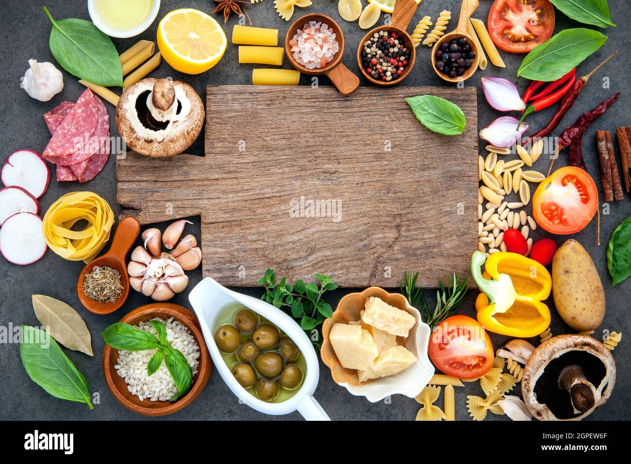 Italian food cooking ingredients on dark stone background with cutting ...