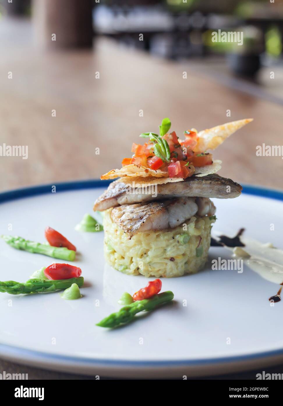 Fillet sea bass with vegetable and rice Stock Photo - Alamy