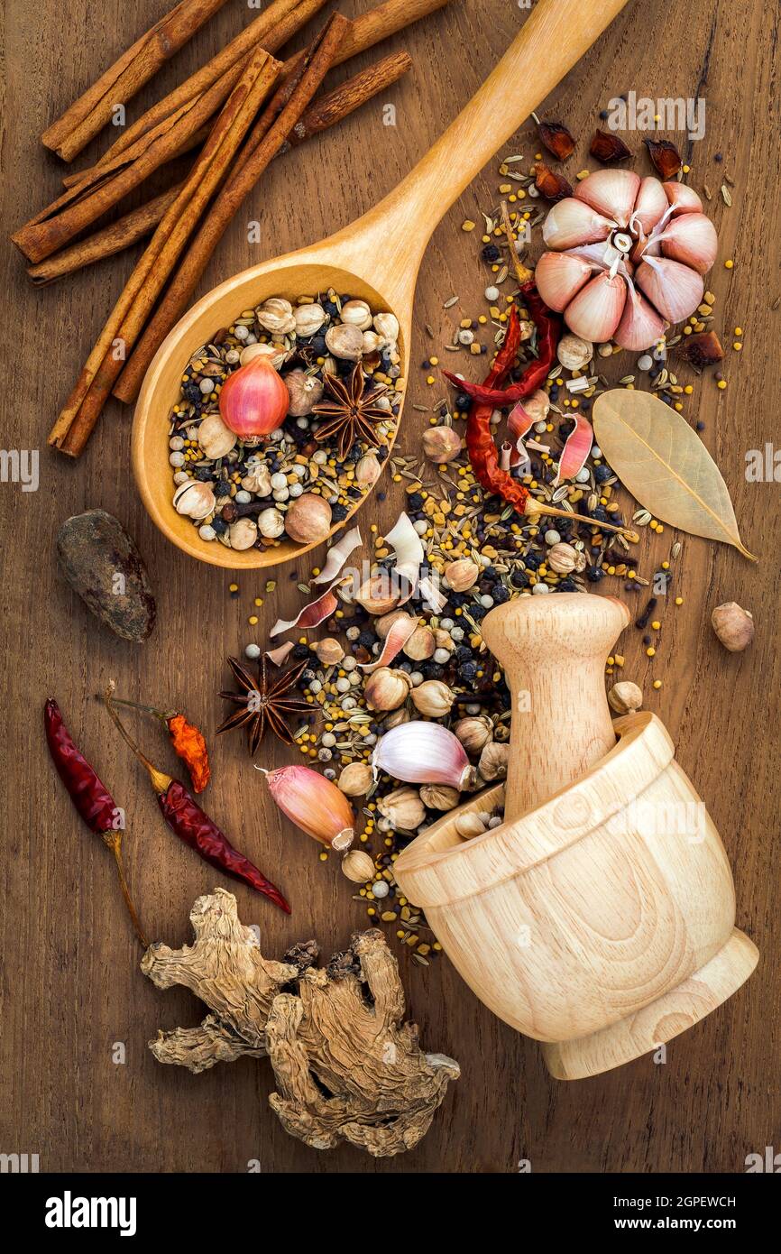 Assorted of spices in wooden spoon black pepper ,white pepper, black ...