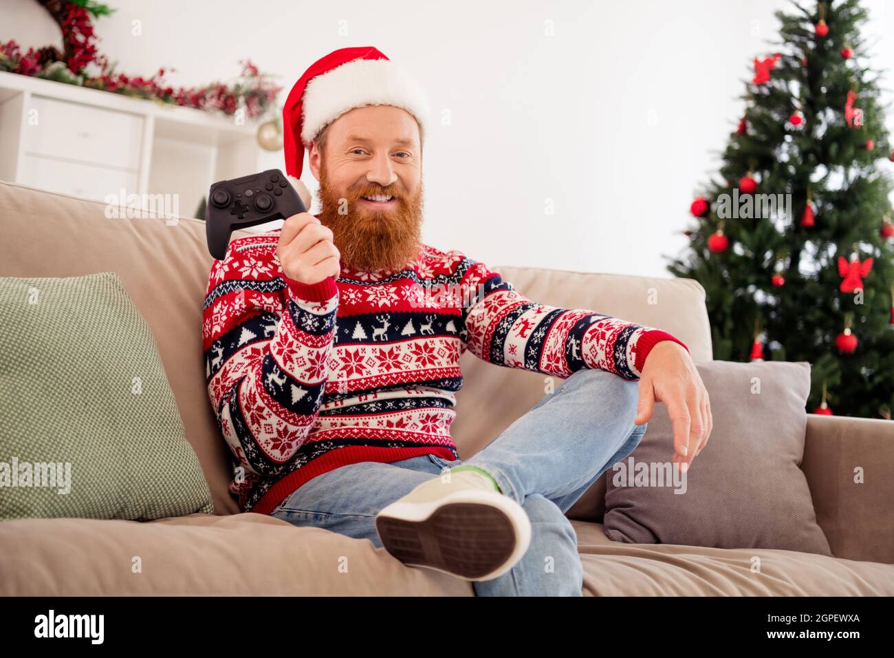 Photo of handsome smiling ginger guy sit sofa relaxing at home ...