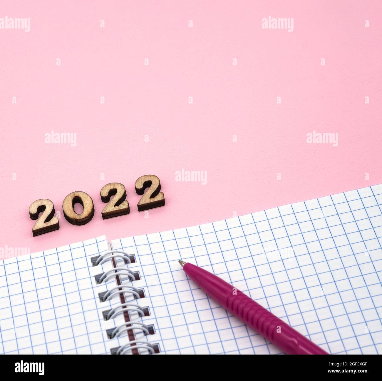 Wooden numbers 2022. Notepad on a spring. Notepad and Pen on Pink. Pink ...