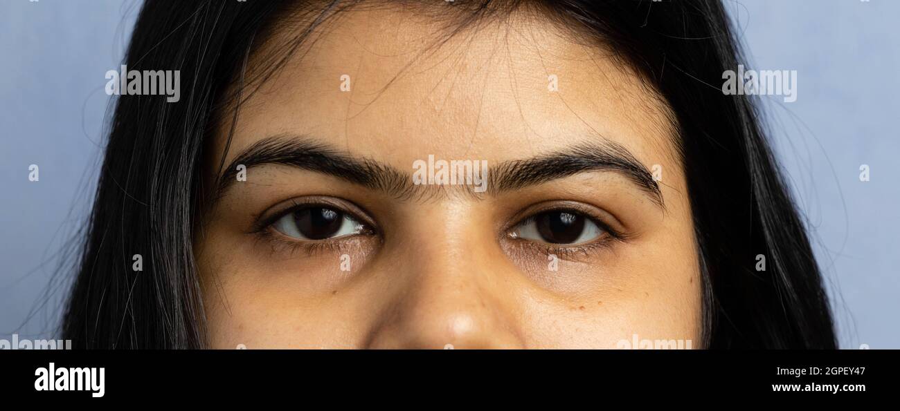 Close up view of unibrow of a woman Stock Photo - Alamy
