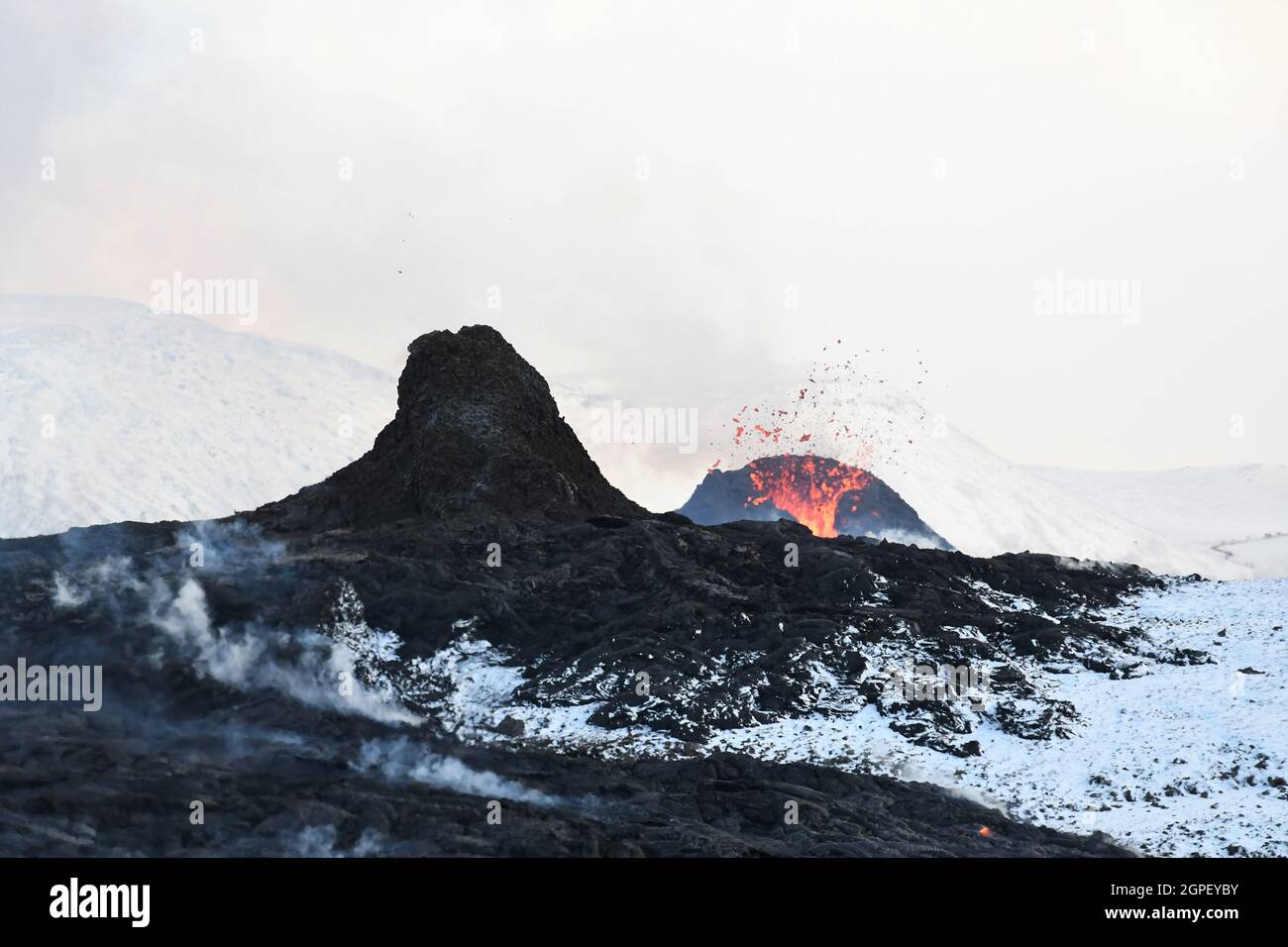 Two vents at the Fagradalsfjall eruption in Iceland. Black lava field ...