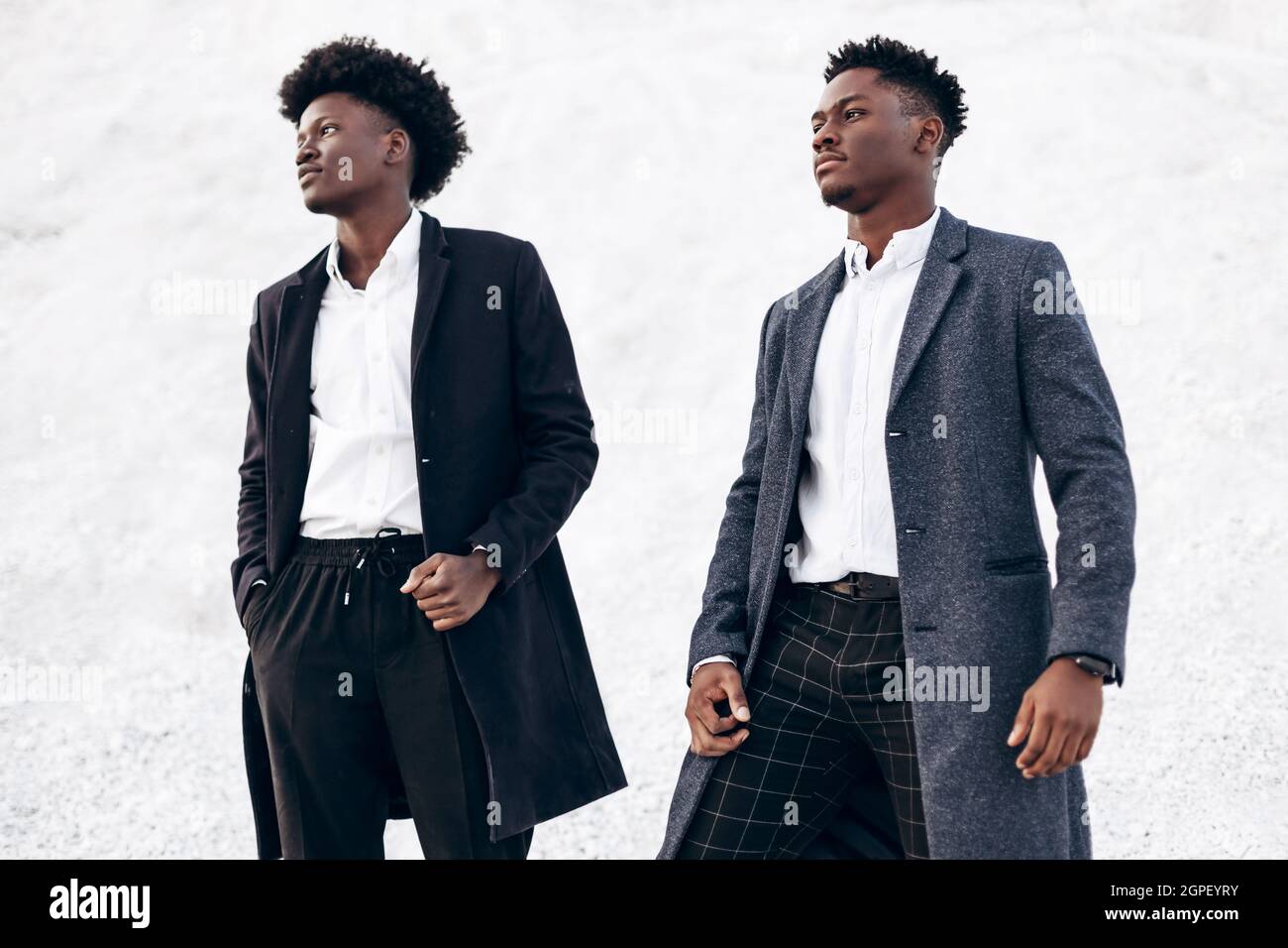 Two trendy African black men, outdoors, in stylish classic clothes ...