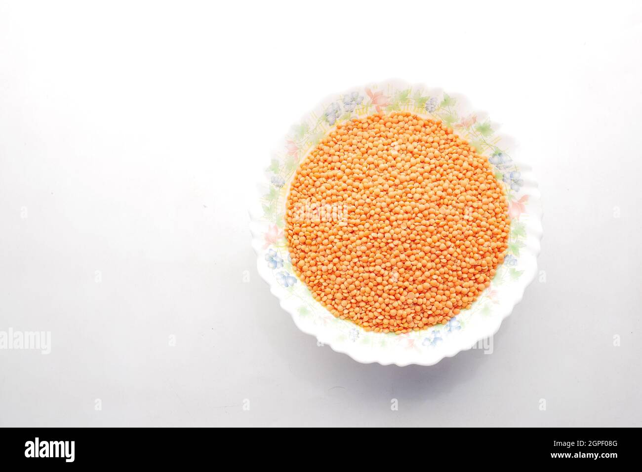 Bowl of uncooked dhal on white Stock Photo - Alamy