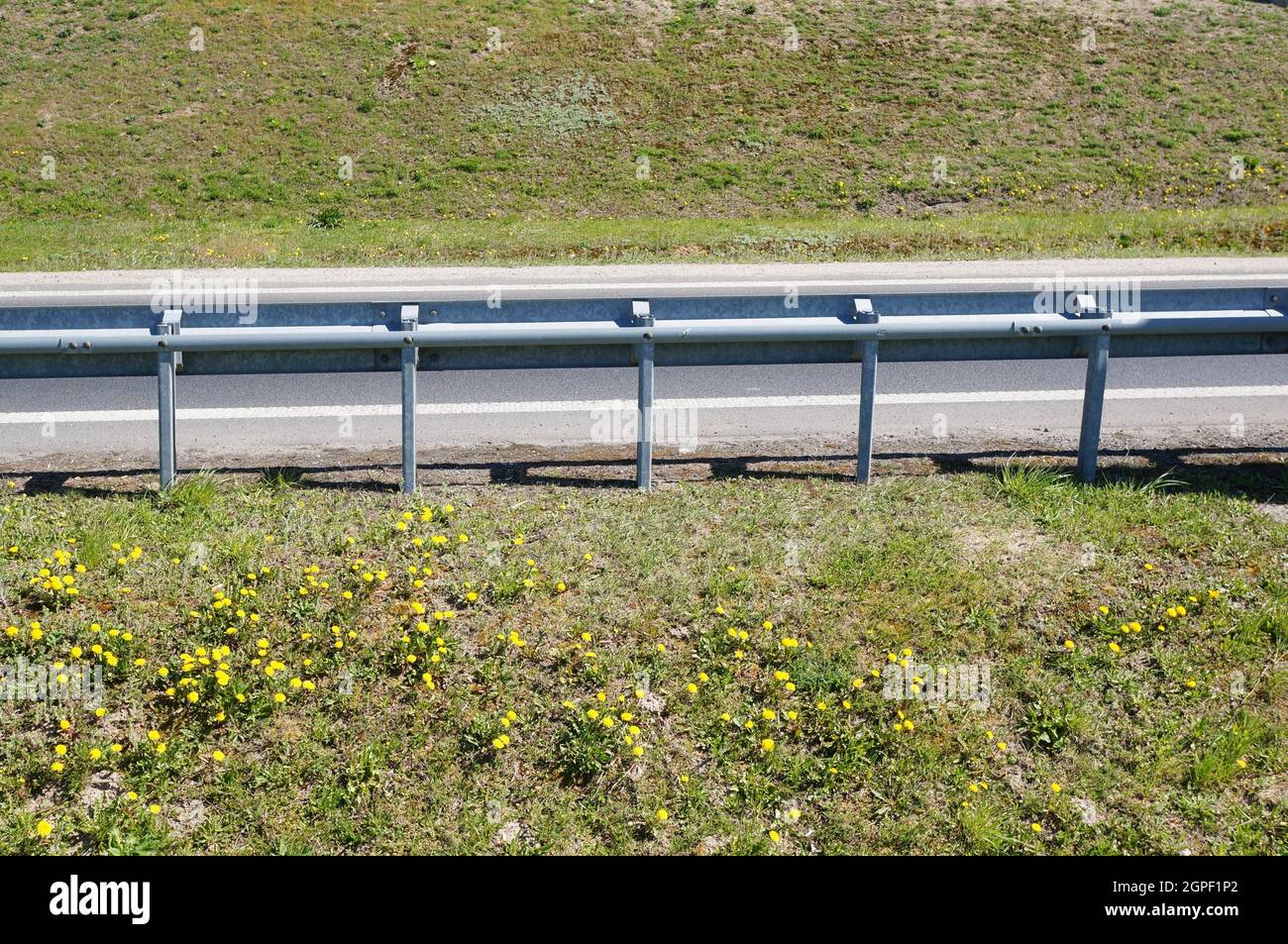 Metallic fence on the asphalt road outdoor Stock Photo - Alamy