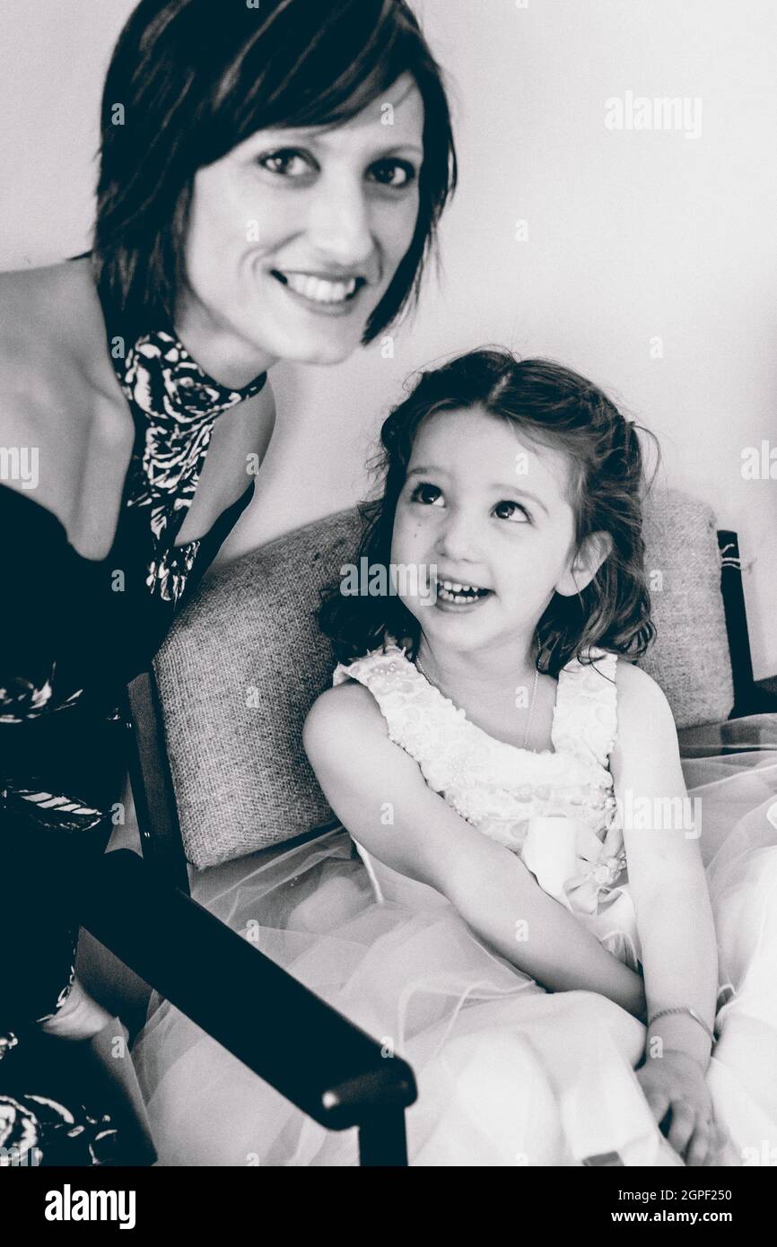 A greyscale portrait of Caucasian mother and daughter posing for the ...