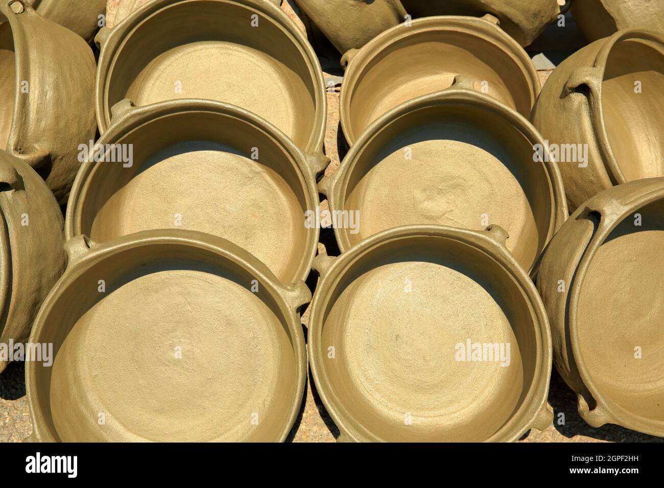 Handmade, traditional terracotta pots. Stacked look after wood fire ...