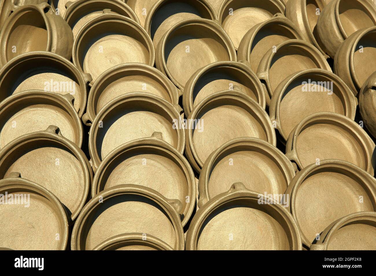 Handmade, traditional terracotta pots. Stacked look after wood fire ...