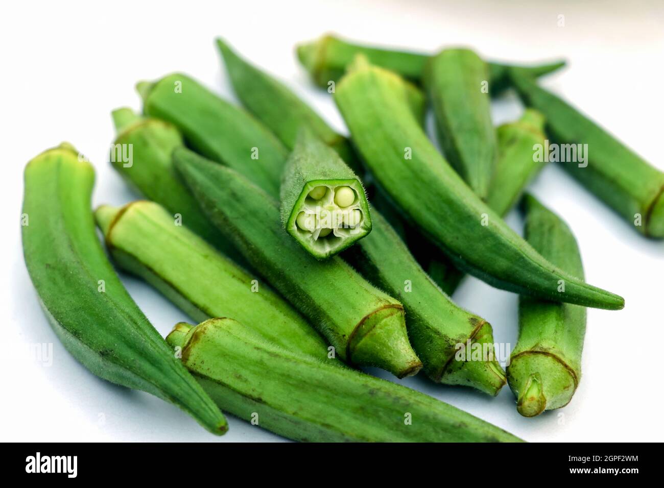 Raw okra or ladyfingers isolated on white background Stock Photo - Alamy
