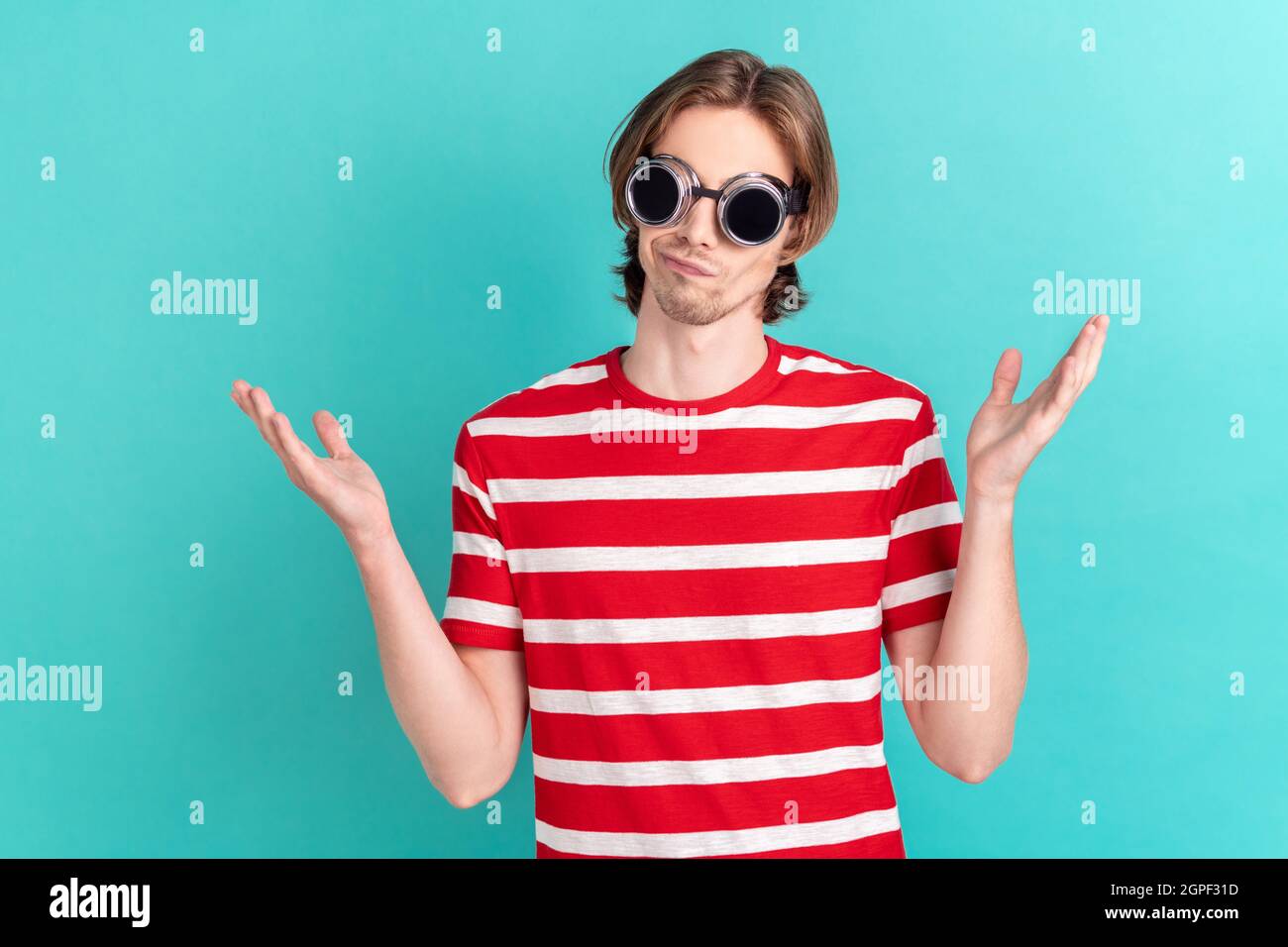 Portrait of attractive clueless guy wearing pilot specs shrugging ...