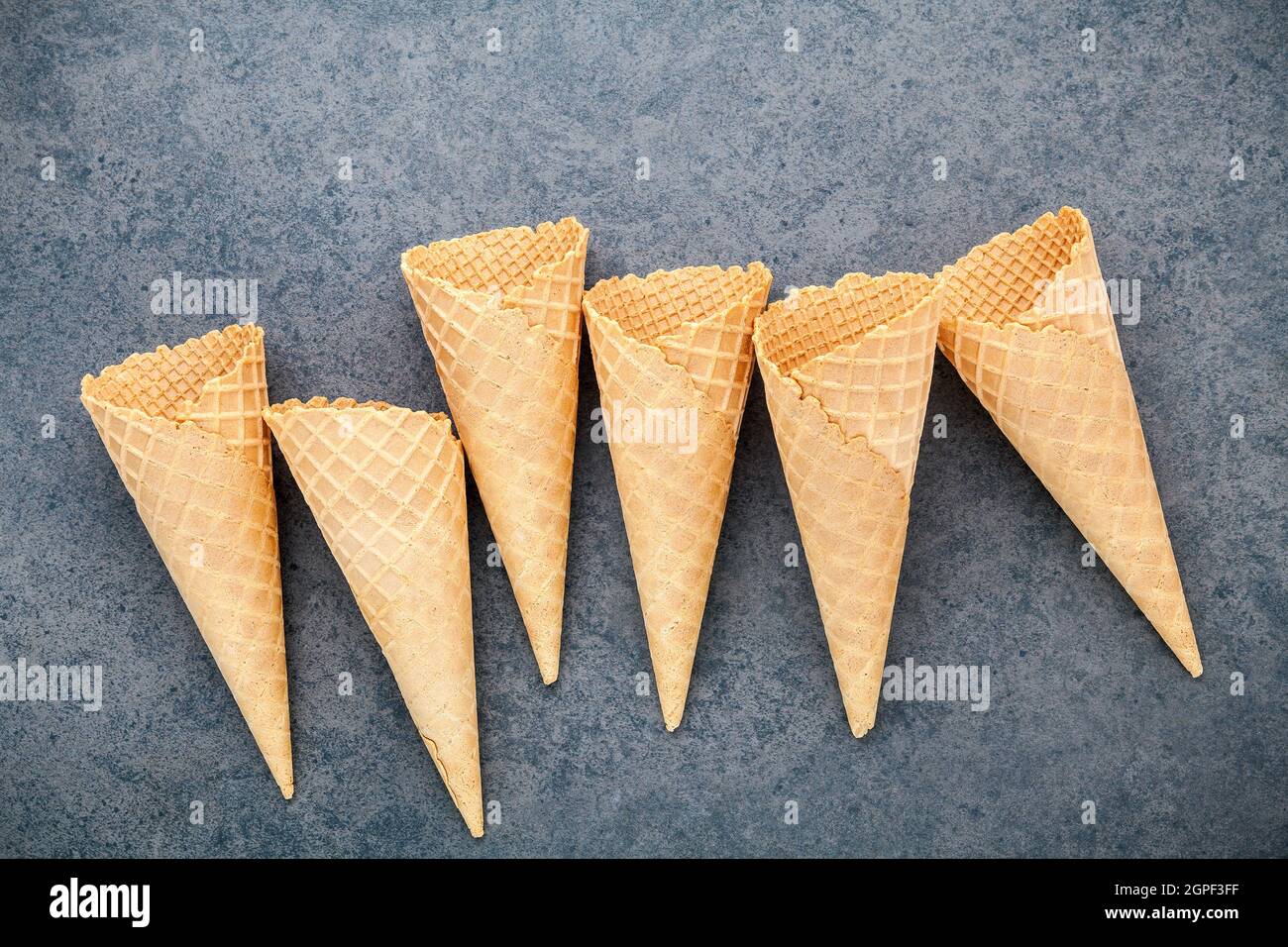 Flat lay ice cream cones collection on dark stone background . Blank ...