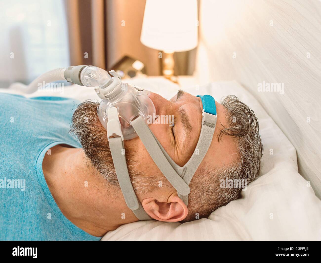Sleeping man with chronic breathing issues considers using CPAP machine ...