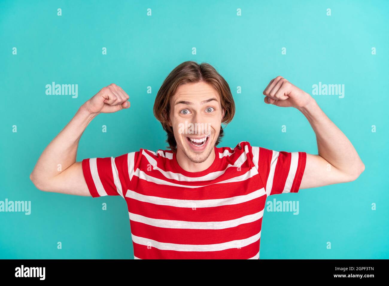 Photo of young guy happy positive smile hold hands muscles biceps ...