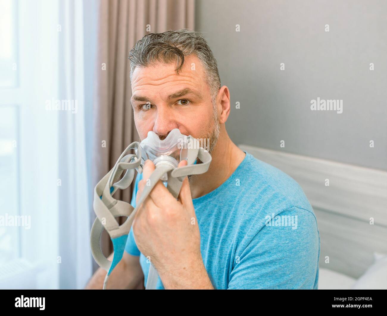 Mature happy man with chronic breathing issues considers using CPAP ...