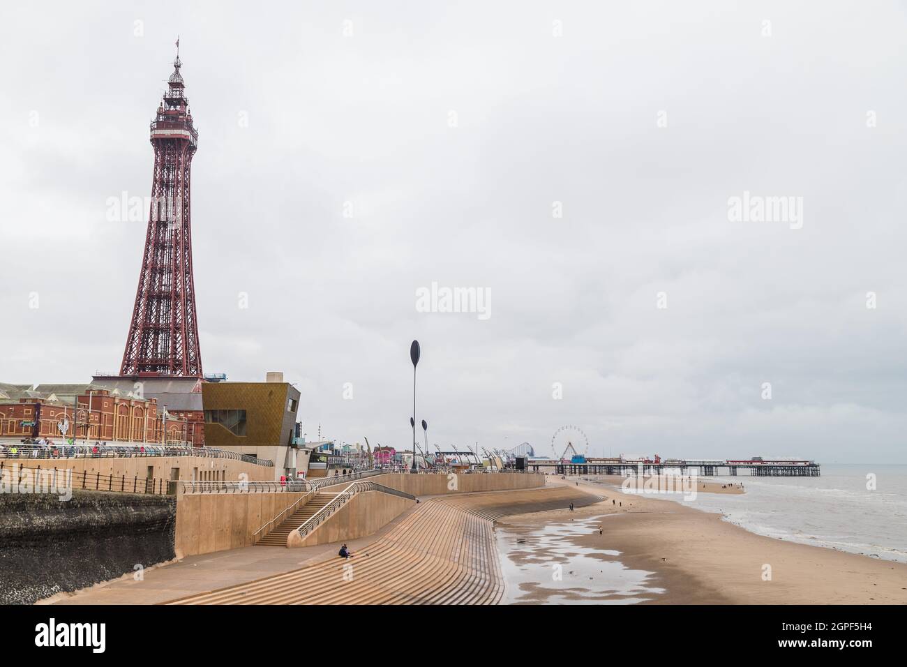 Blackpool Tower pictured next to the Central Pier on a cloudy morning ...