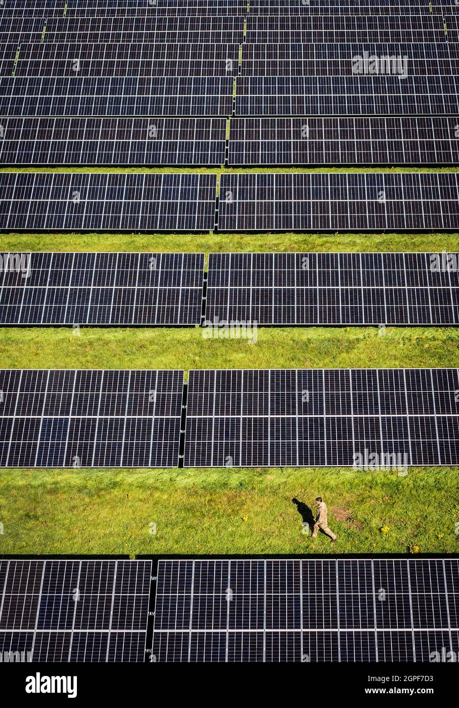 Major David Owen walks through a field of solar panels at the opening ...