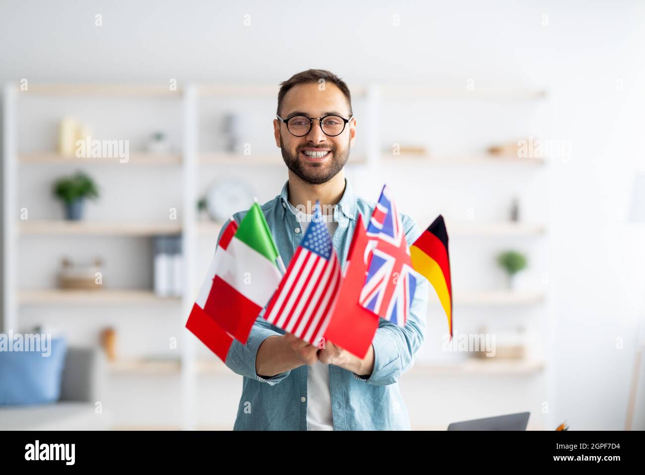 Modern education and student exchange. Cheerful young Caucasian guy ...