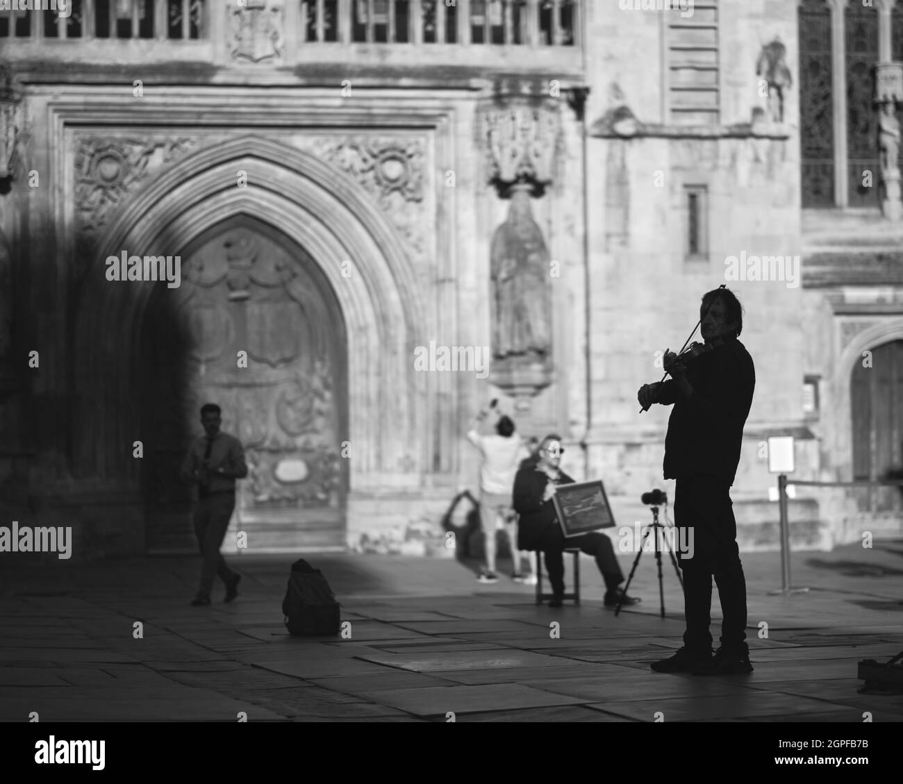 Busker outside Bath Abbey in black and white Stock Photo - Alamy