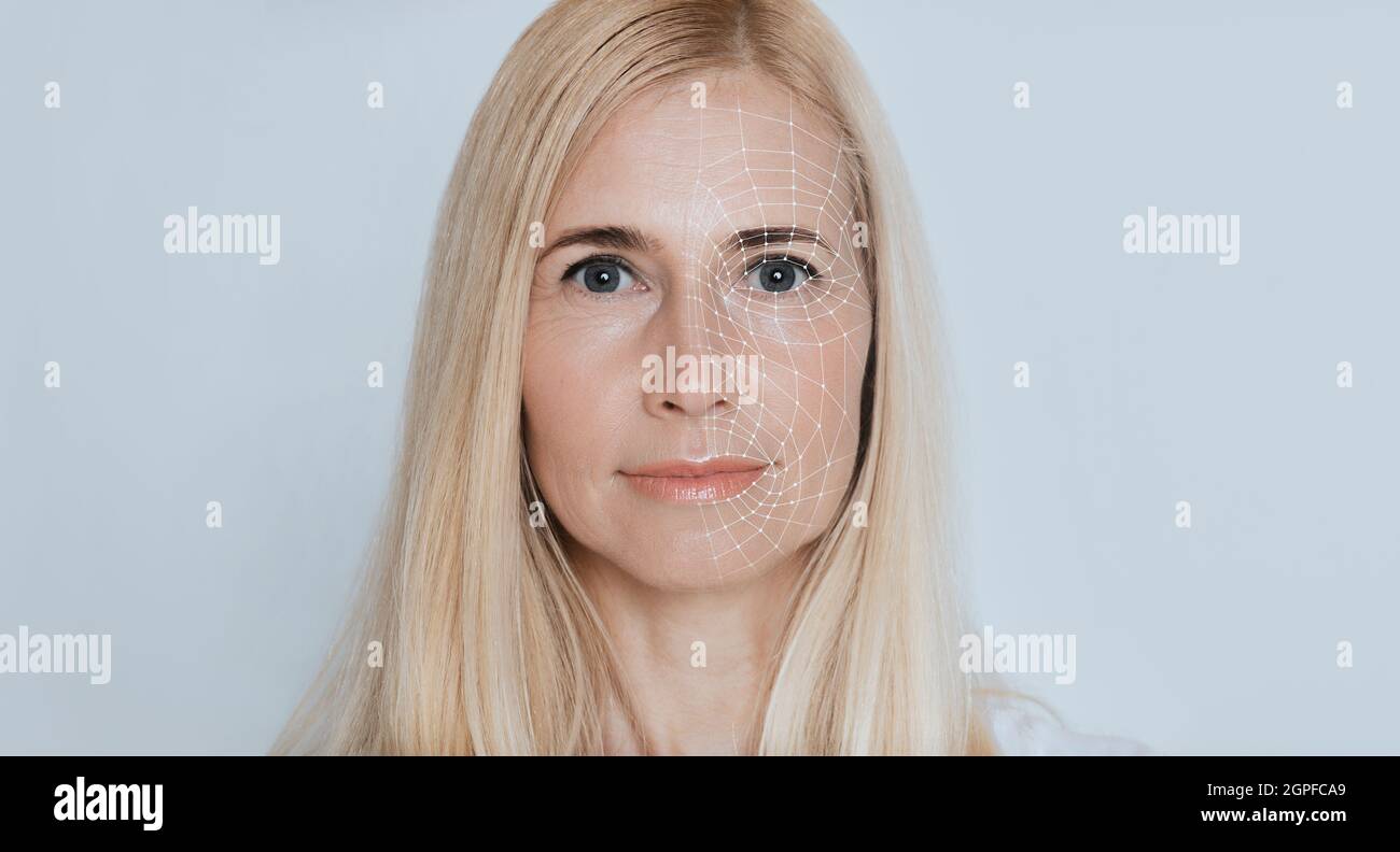 Blonde lady getting face scanning on studio background, closeup ...