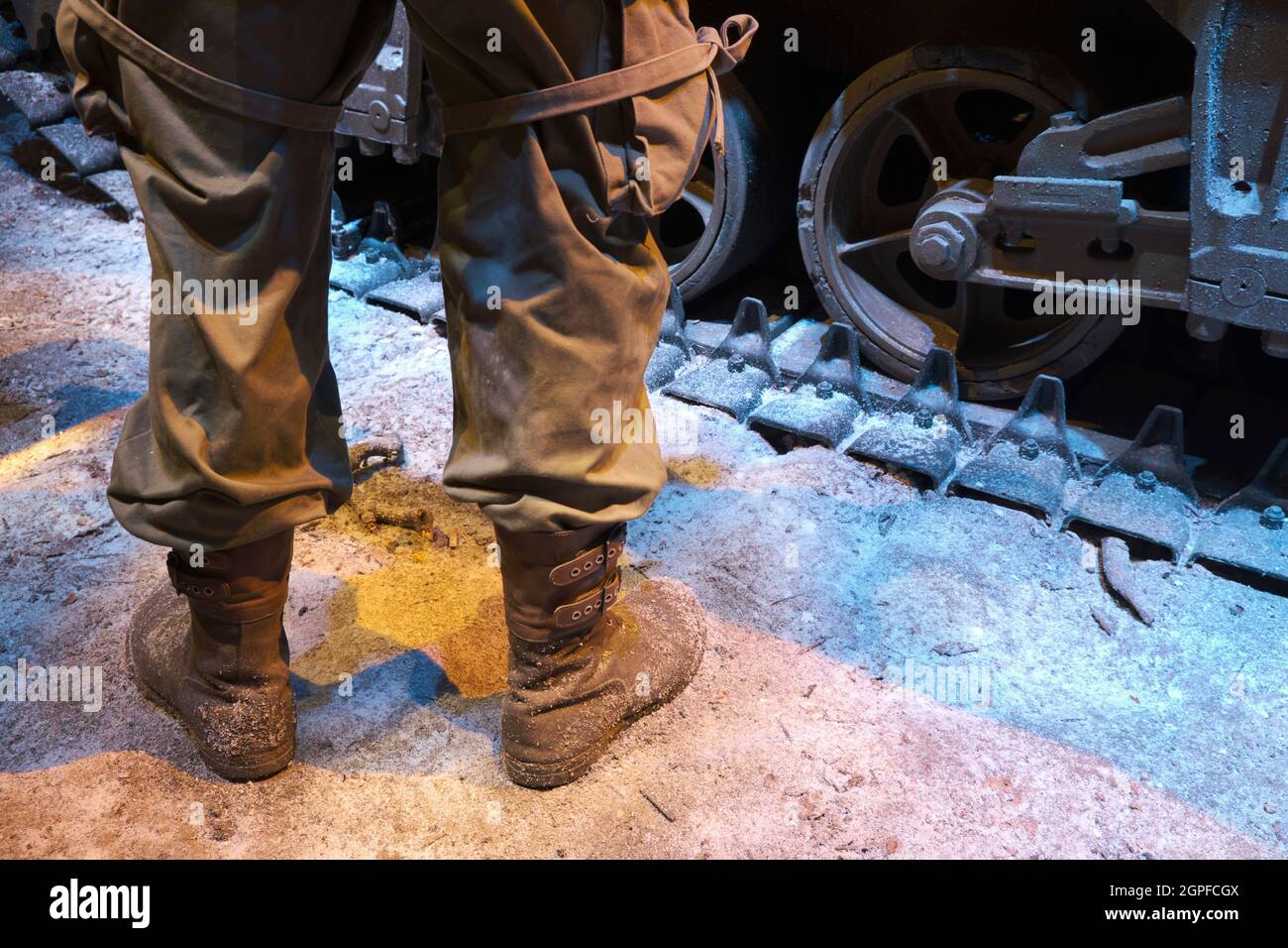 A soldier's boots during winter in WWII by a Sherman tank tread. At the ...