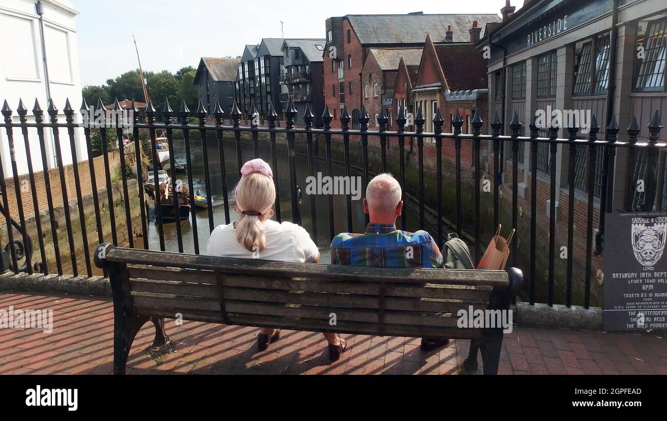 A couple seated by the bridge over the River Ouse in Cliffe High Street ...