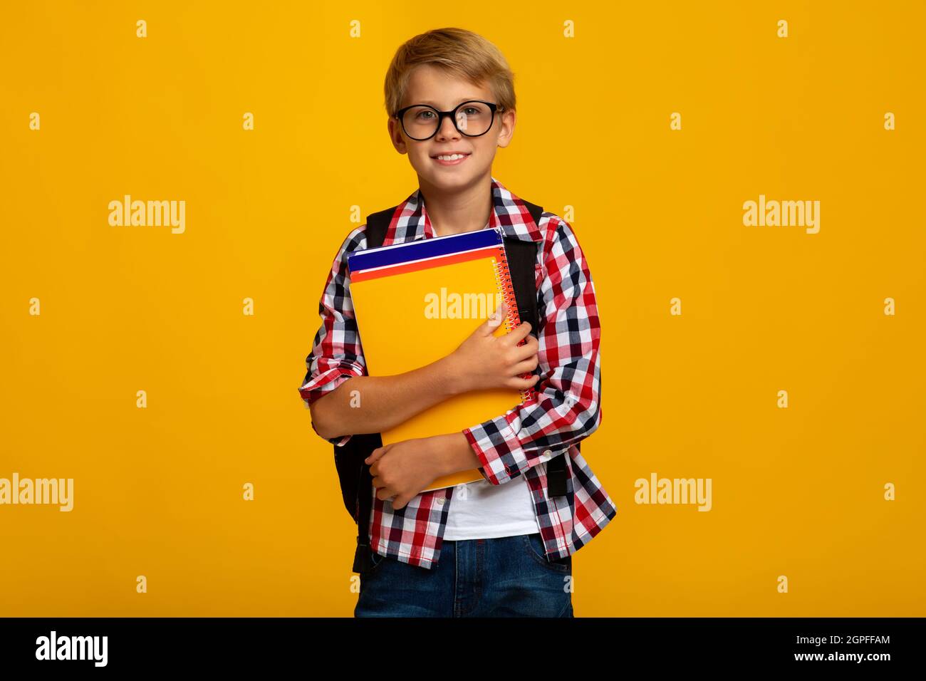 Happy calm caucasian teenager boy wearing casual in glasses with books ...