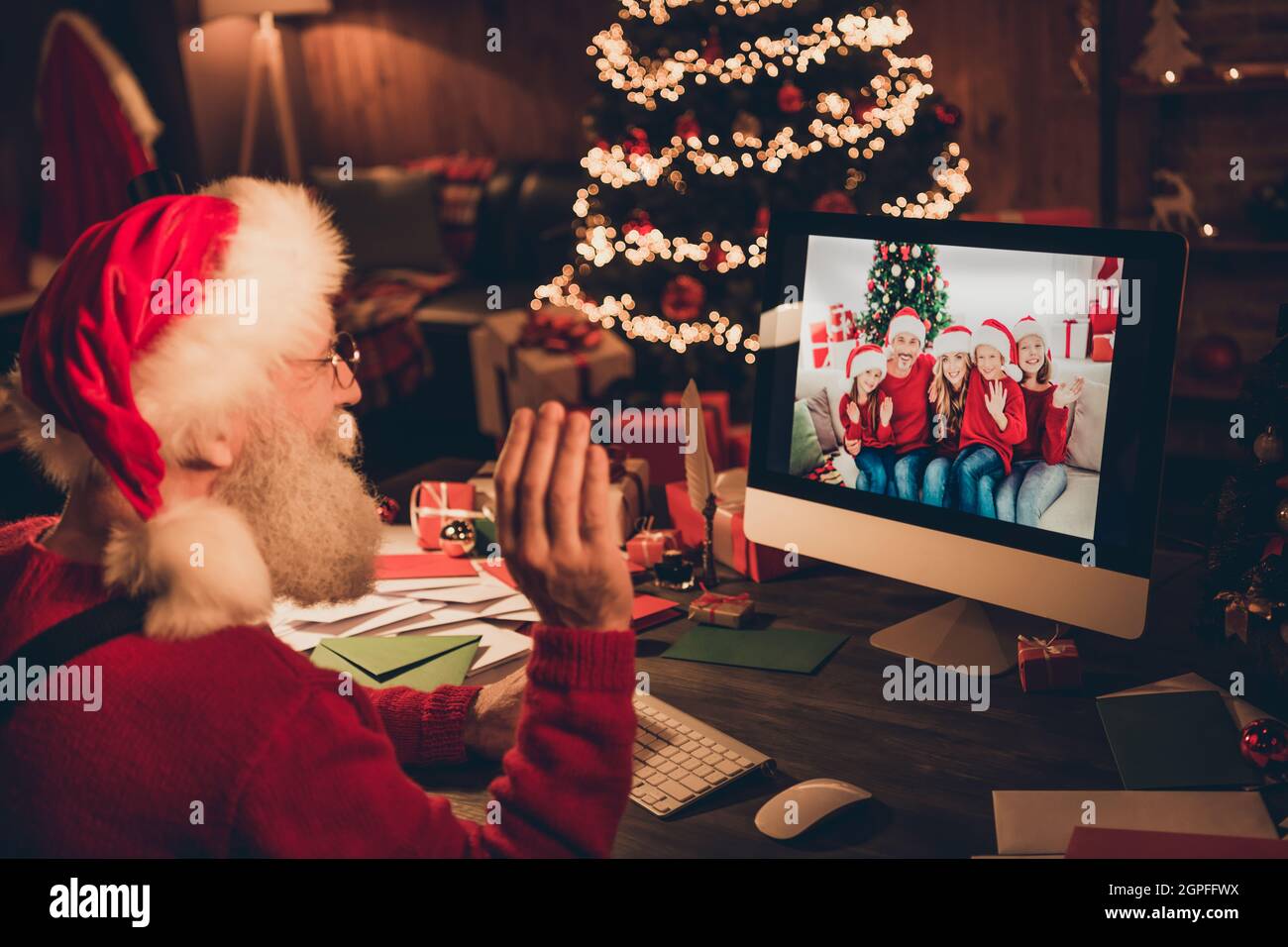 Back view photo portrait santa talking on video connection waving to ...