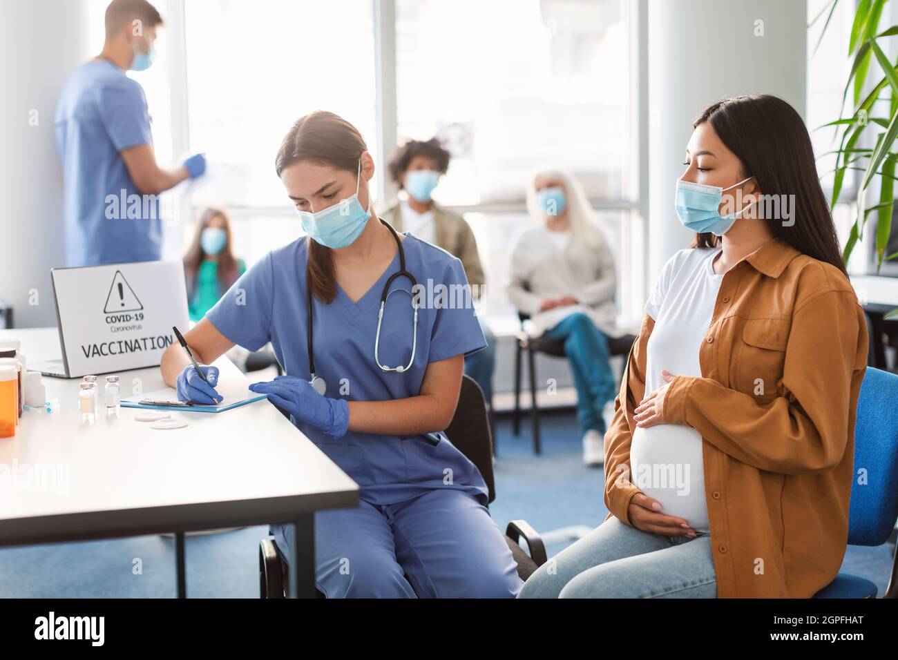 Registration. Doctor Examining Pregnant Patient Before Appointment In ...