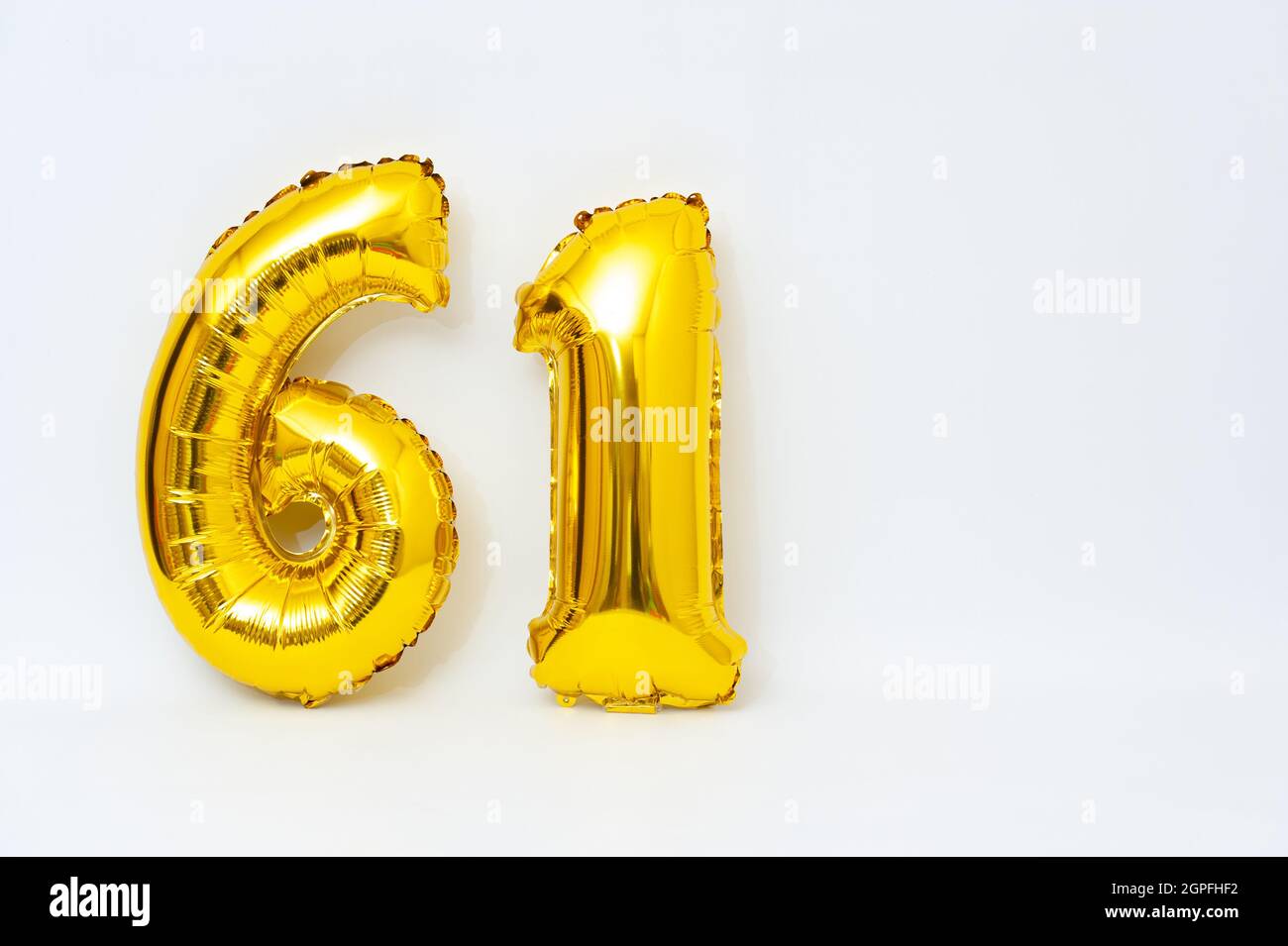 Inflatable numeral 61 sparkling metallic golden color isolated on white ...