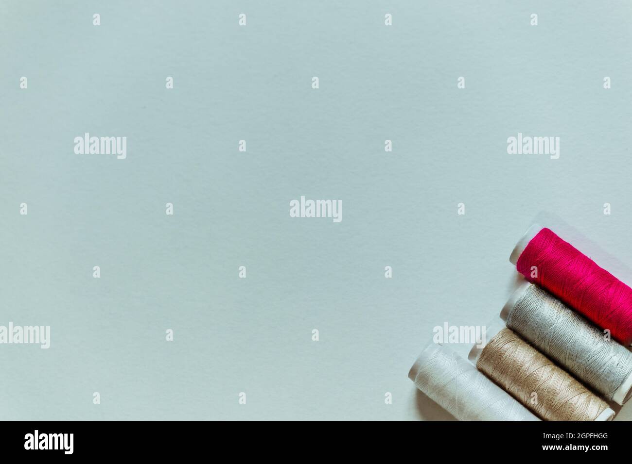 White background with four skeins of thread in the corner Stock Photo ...