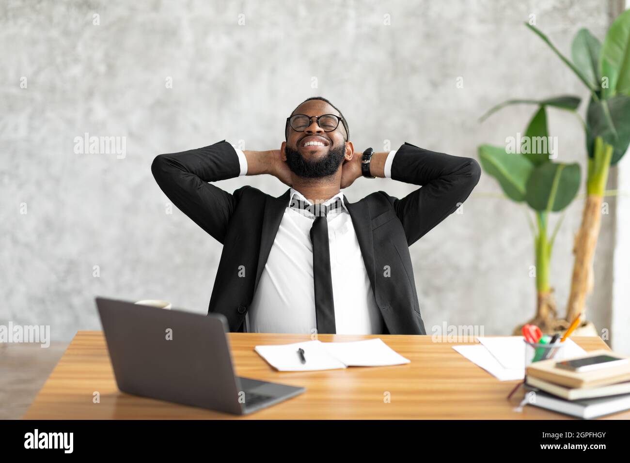 African American man leaning back taking break Stock Photo - Alamy