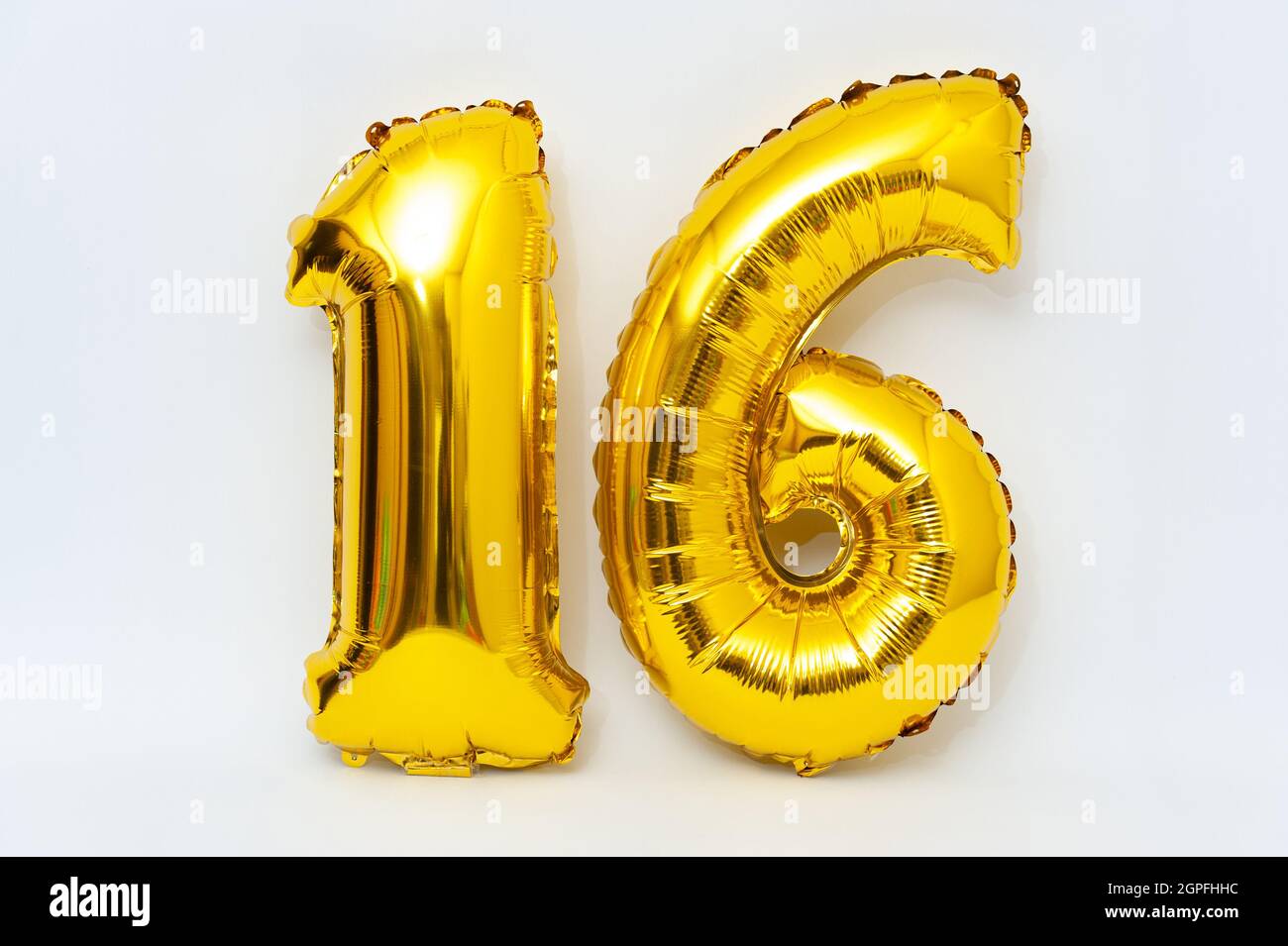 Inflatable numeral 16 sparkling metallic golden color isolated on white ...