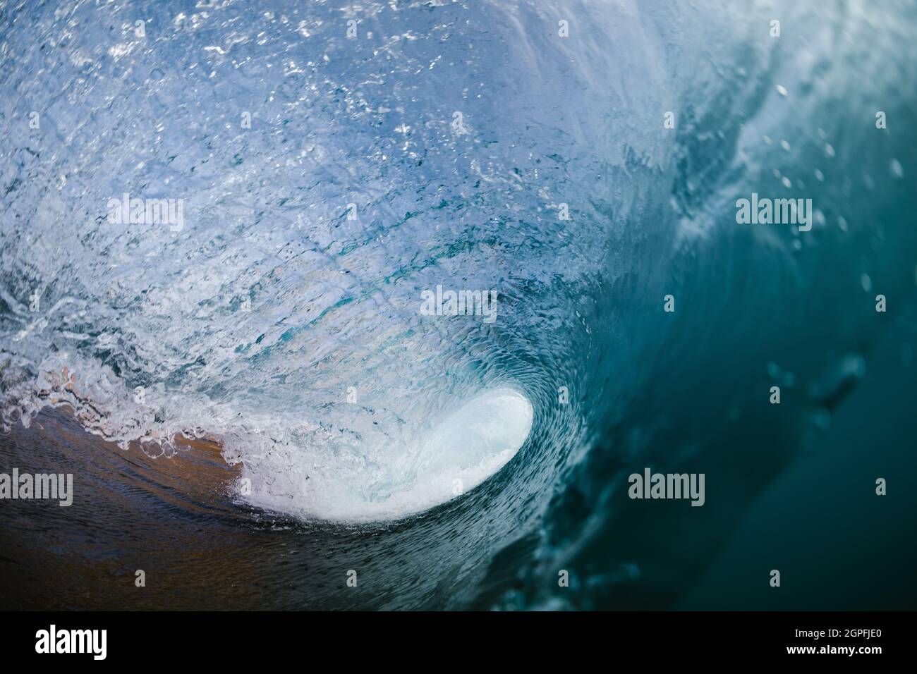 Inside a blue wave breaking on the beach Stock Photo - Alamy