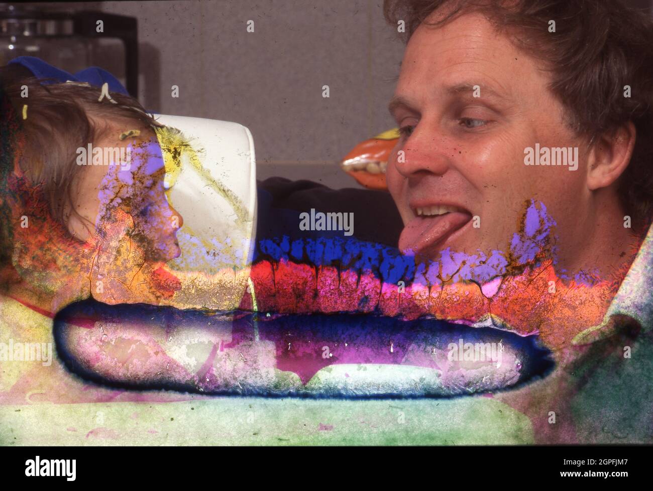 Austin Texas USA, 1995: Anglo baby boy, 10 months old, sticks out his ...