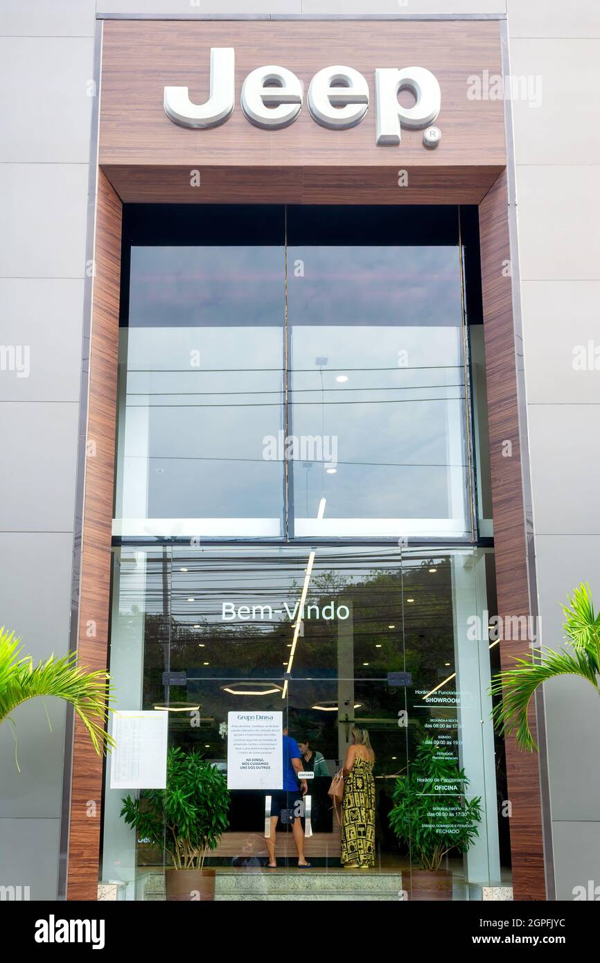 Jeep logo or sign on top of a glass window in a car business dealership ...