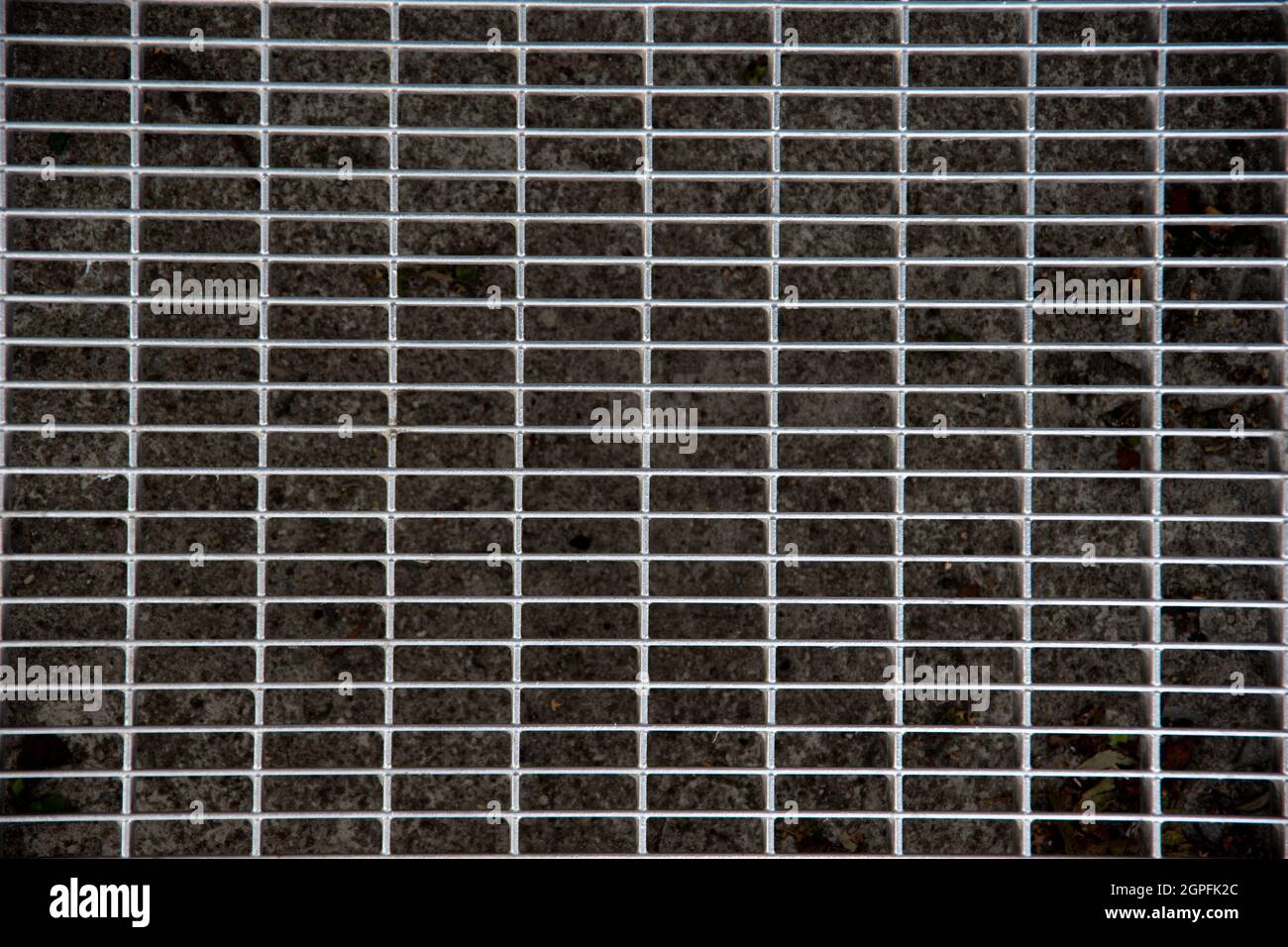 Old metal grating in the sidewalk. The metal gauze of a drainage, Close ...