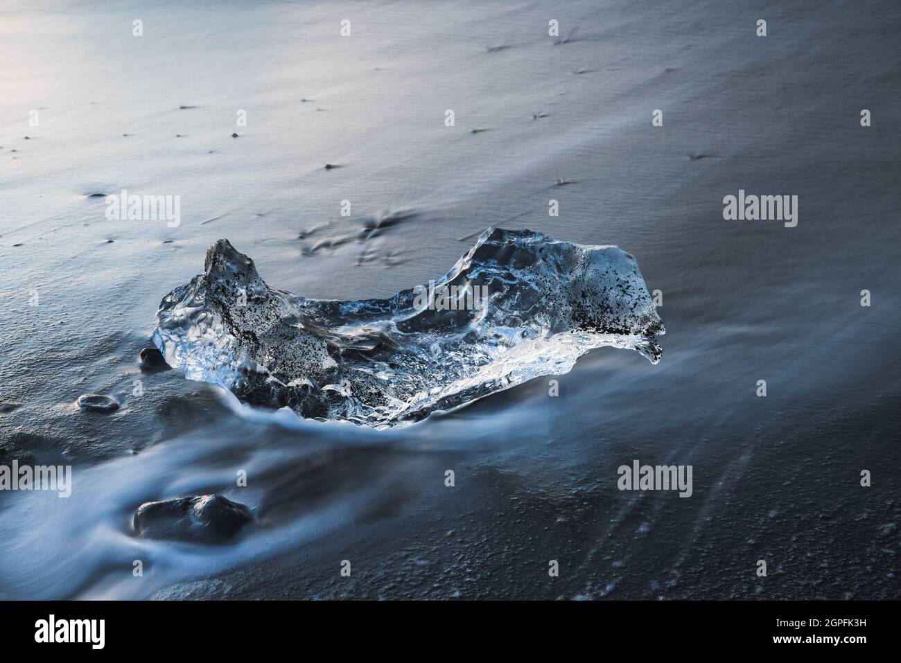 ice block over black sand in diamond beach Stock Photo - Alamy