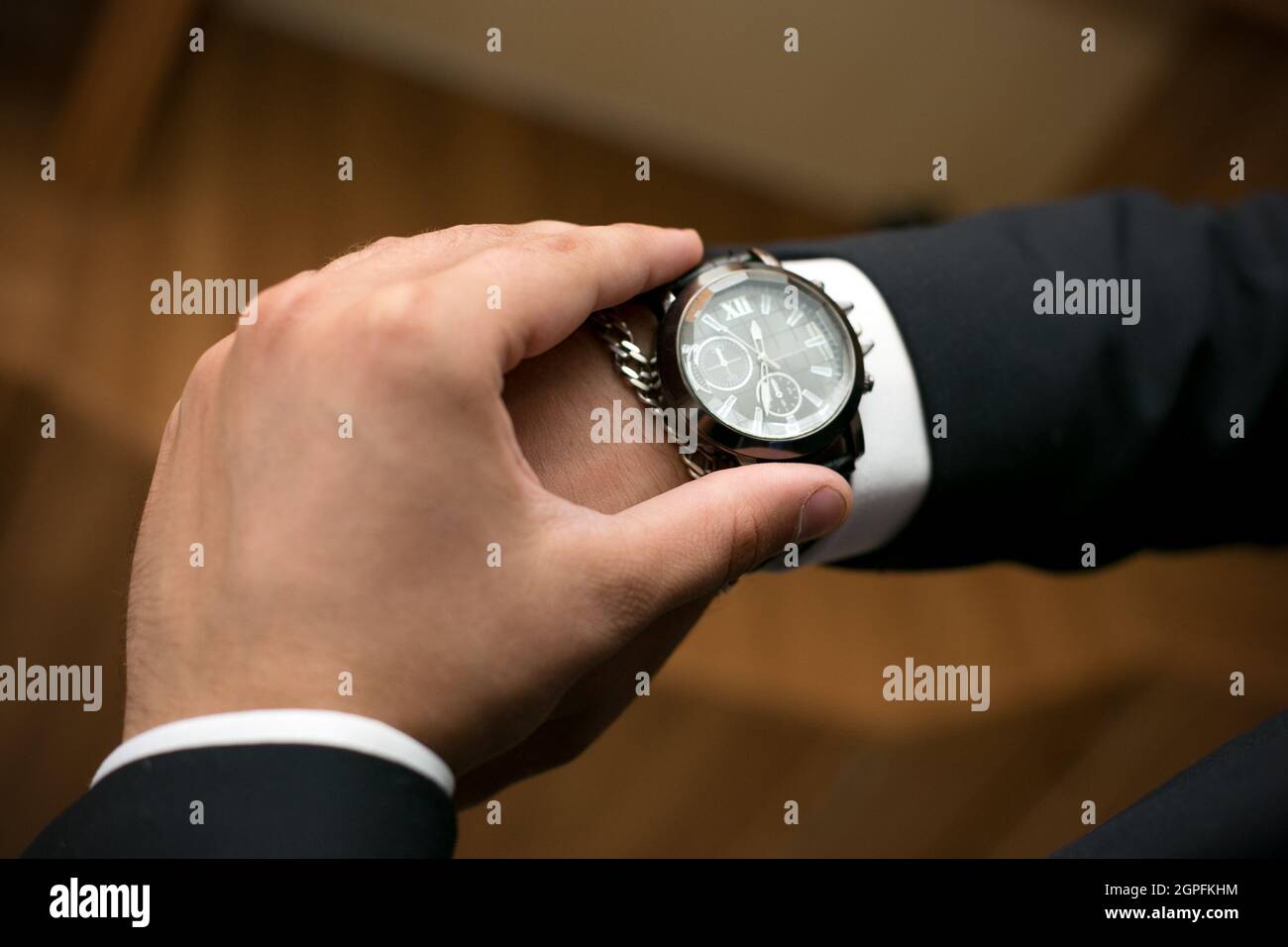 A man looks at his wristwatch afraid of being late for a date Stock ...