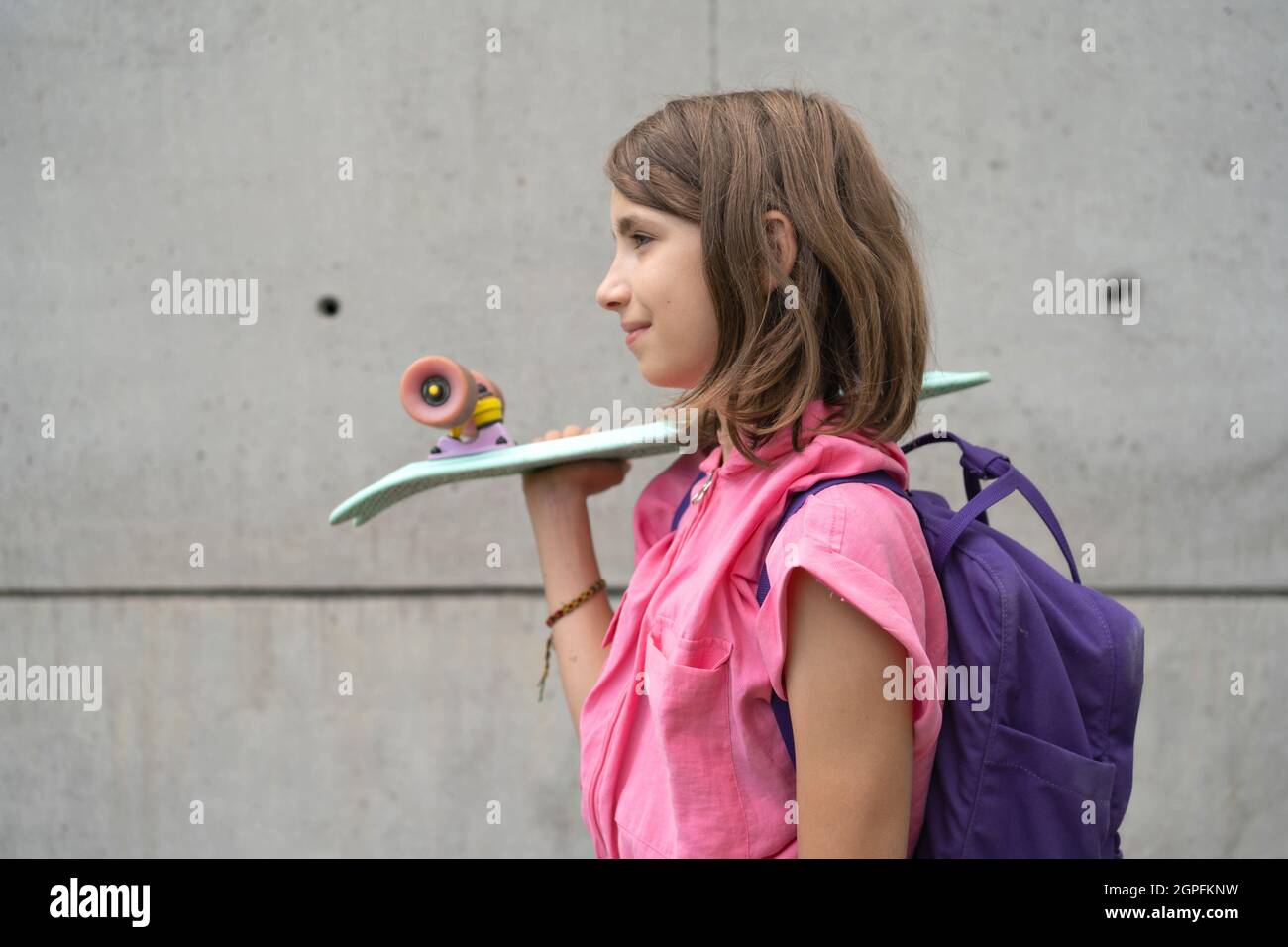 Teenage girl carrying skateboard on shoulder outdoors Stock Photo - Alamy
