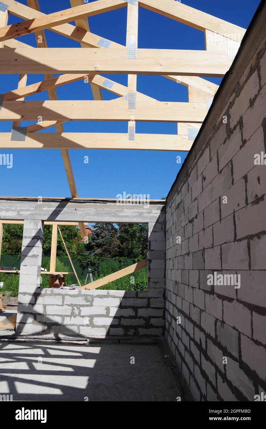 House construction with roof beams, trusses, wooden frame beams on ...