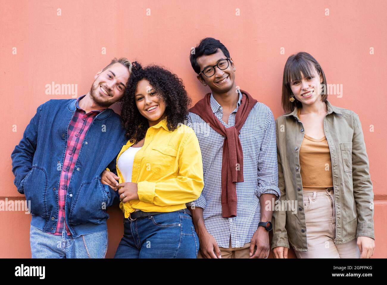 Multiracial friends group having fun at wall on university college ...
