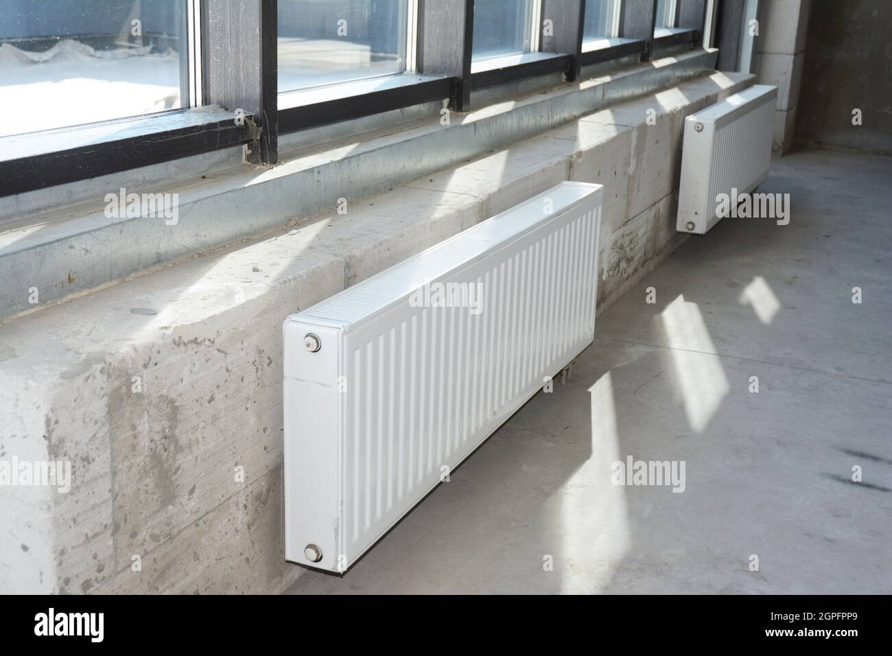 Installing radiators heating in the unfinished house empty room ...