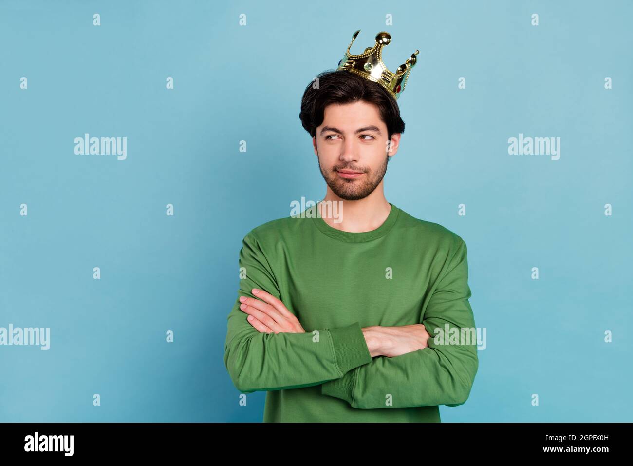 Photo of young egoistic selfish smiling guy in crown crossed hands look ...