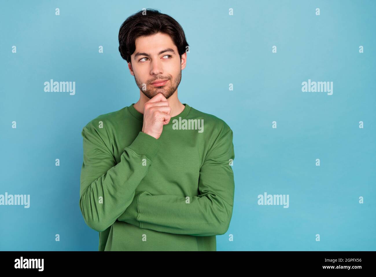 Photo of young thoughtful minded smiling guy thinking look copyspace ...
