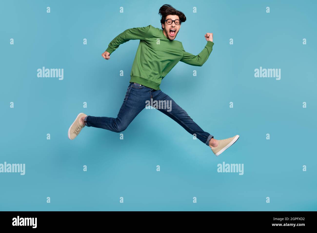 Full length photo of cheerful crazy happy man jump up run empty space ...